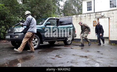 Members of the Close Protection Unit Royal Military Police clear a ...