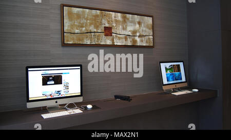 Hotel Receptionist Using Computer And Phone Stock Photo - Alamy