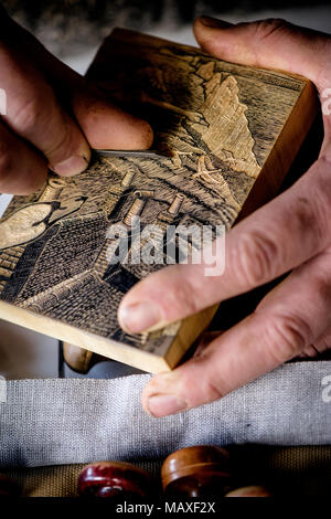 Craftsman Keith Pettit working on one of his wood engravings depicting ...