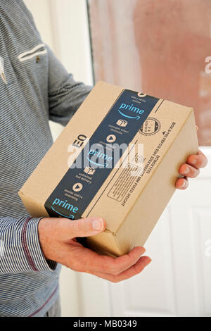 holding package of Amazon Prime cardboard package with UN3481 sticker ...