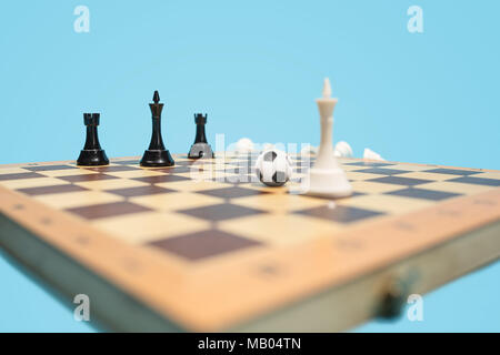 soccer ball of chess pieces on the board Stock Photo - Alamy