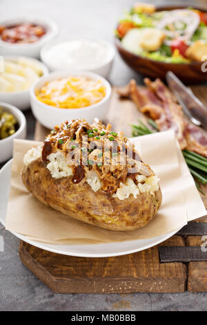Roasted pork meat with baked jalapenos and jacket potato Stock Photo ...