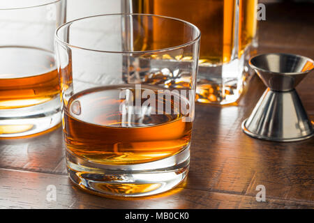 Whiskey neat in shot glass on white background Stock Photo - Alamy