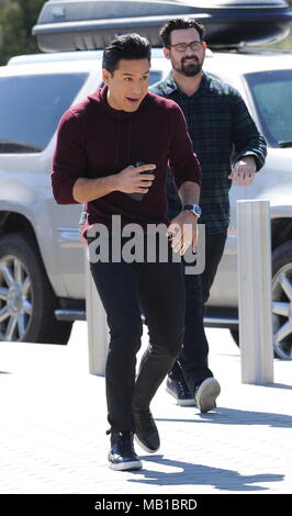 Mario Lopez shows off his boxing moves to a friend on the set of "Extra ...