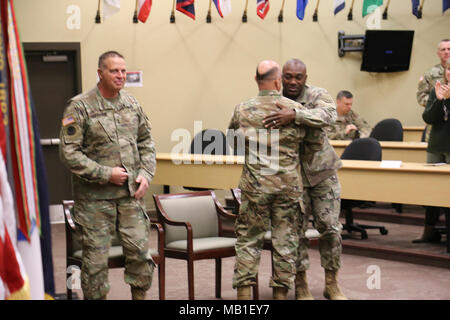 Command Sgt. Major Levi Maynard congratulates incoming commander Maj ...