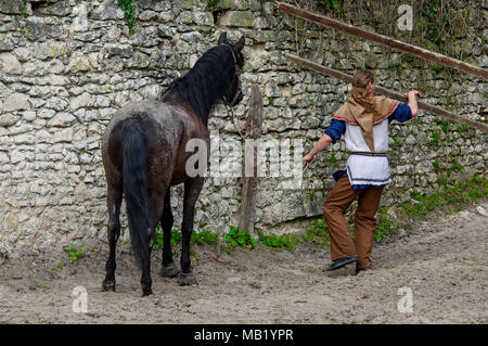PROVINS, FRANCE - MARCH 31, 2018: Unidentified man carries a carriage ...
