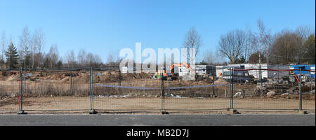 View of the large site with contruction fence and sign. At the huge ...