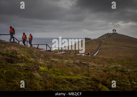 Explorers walking, in background Albatross memorial for lost mariners ...