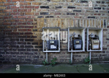 Streetside Electrical Boxes against brickwork wall Stock Photo - Alamy