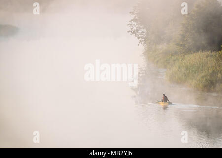 Old fisherman fishing from a wooden boardwalk at Trillium Lake with the ...