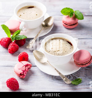 Cup of coffee with french raspberry macaroons Stock Photo - Alamy