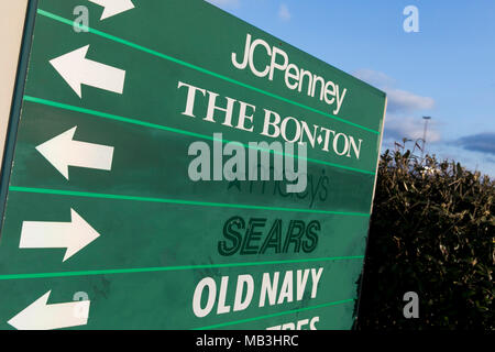 A shopping mall directional sign with the outlines of Sears and Macy's ...