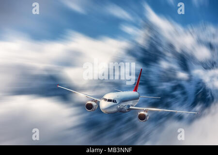 Modern airplane mith motion blur effect travel at sunny bright day ...