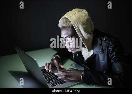 Afro american hacker with no face in the darkness, breaks the access to ...