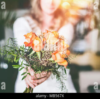 Hand holding An orange rose's petal on a white background Stock Photo ...