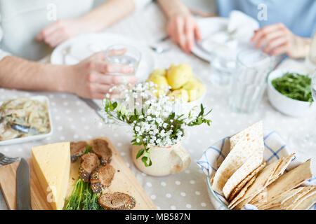 Several slices of fresh rye bread and cheese on wooden board among ...