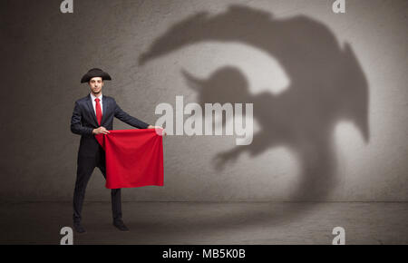 Businessman standing with red cloth in his hand and imp shadow on the ...