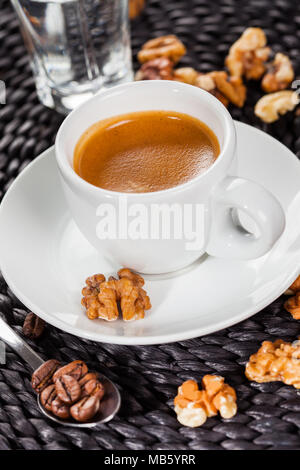 Black espresso coffee and walnuts Stock Photo - Alamy