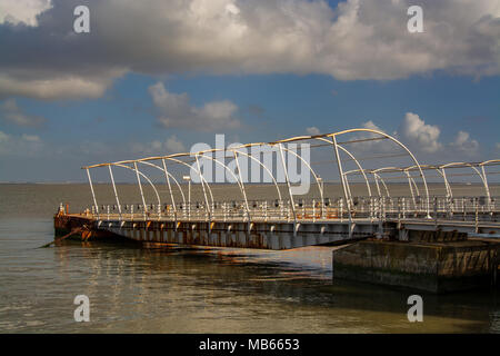 metal rusted structure pier in the water wit blue hazy sky Stock Photo ...