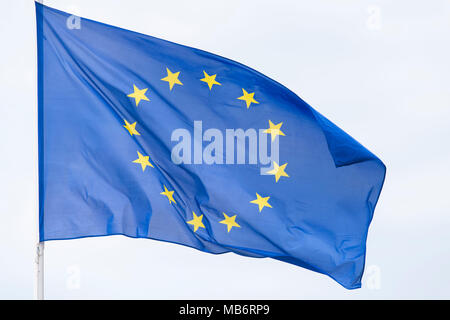 European Union EU flag is flying on blue sky background. Banner, place ...