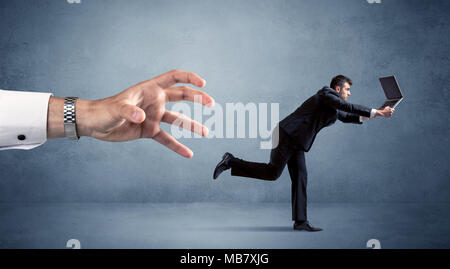 Young miniature businessman running from a big hand with light grey ...