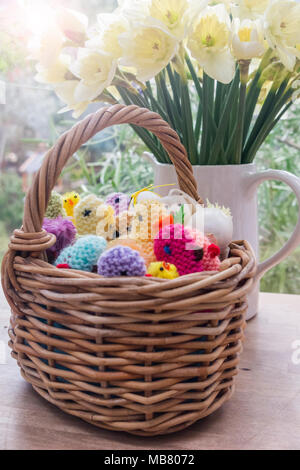 Cute chickens, Easter eggs and flowers on light table Stock Photo - Alamy