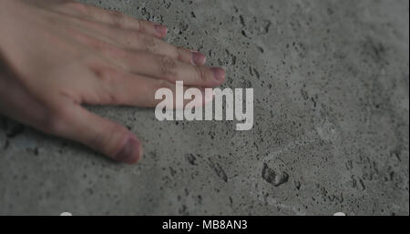 handheld of man hand touching concrete wall, wide photo Stock Photo - Alamy