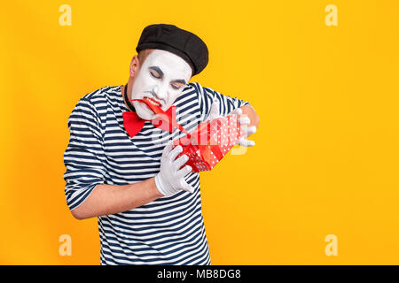 Mime man open red gift box . Emotions and feelings concept. Indoor shot ...