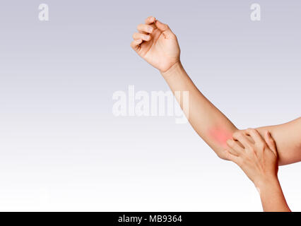 left hand scratching right arm around elbow joint Stock Photo - Alamy