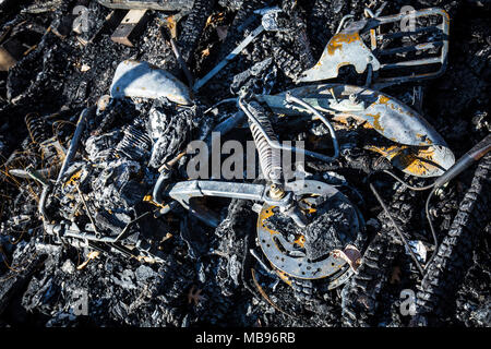 Burned motorcycle after an accident lying down Stock Photo - Alamy