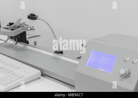 laboratory equipment measures the quality of cotton thread for strength ...