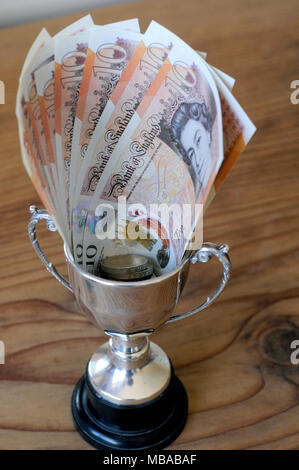 Small winners trophy with a cash prize of ten pound notes in the cup ...