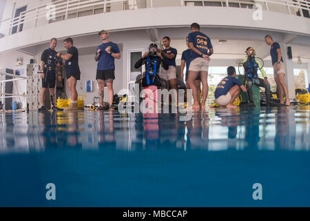 A U.S. Air Force dive school student hydrates during a training session ...