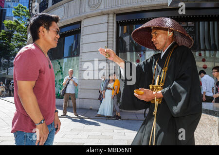 People receiving blessing from priest at temple ceremony, Bali ...