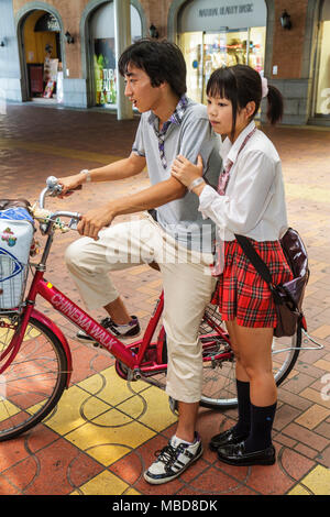 Japanese student girl riding bicycle go back home after finished Stock ...
