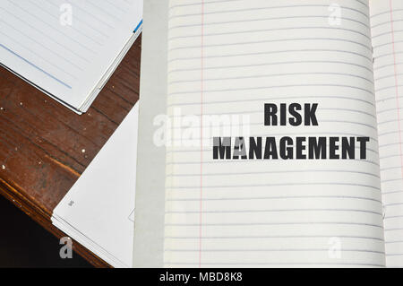 Risk Assessment written on paper note pinned on cork board with white ...