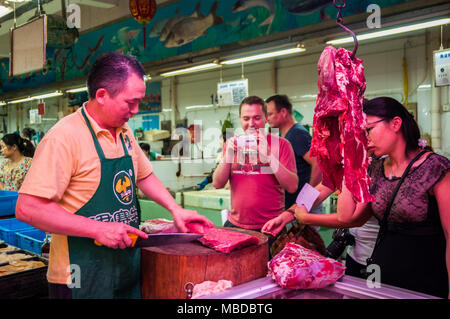 Asian butcher chopping raw meat on a cutting board Stock Photo ...