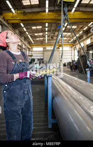 Woman working with metal sheet and using electric drill Stock Photo - Alamy