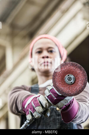 Woman working with metal sheet and using electric drill Stock Photo - Alamy