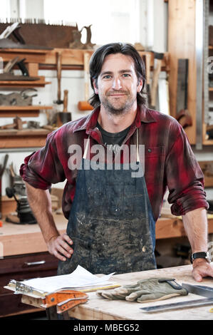 Manual worker with protective black and green work glove holding a ...