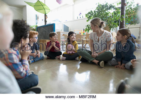Students sitting in circle working together Stock Photo - Alamy