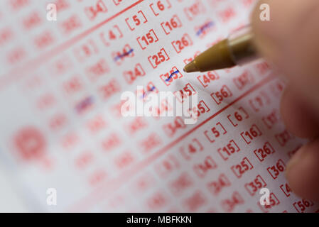 Person's Hand Marking Number On Lottery Ticket With Pen Stock Photo - Alamy