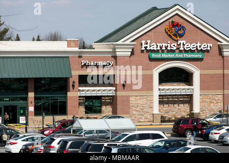 A logo sign outside of a Harris Teeter grocery retail store location in ...