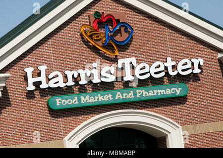 A logo sign outside of a Harris Teeter grocery retail store location in ...