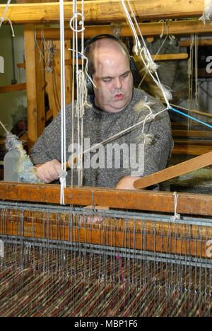 A skilled hand weaver operating a 110-year-old Fly Shuttle Loom at the ...