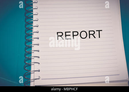 Weekly report message written on torn paper with red background ...