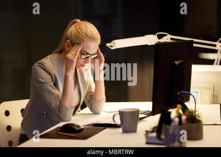 Anxious young woman office manager biting her nails sitting at ...