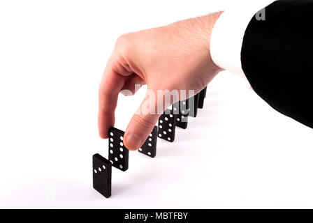 Finger push dominoes and they fall isolated on a white background Stock Photo - Alamy
