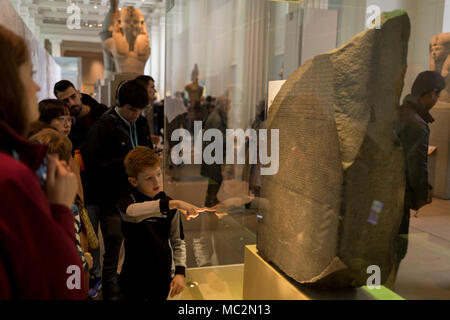Visitors admire the Rosetta Stone in Room 4 of the British Museum on 11th April 2018 in London England Stock Photo Alamy