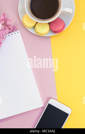 Top view of a yellow smartphone on a blue background with "smile" and ...
